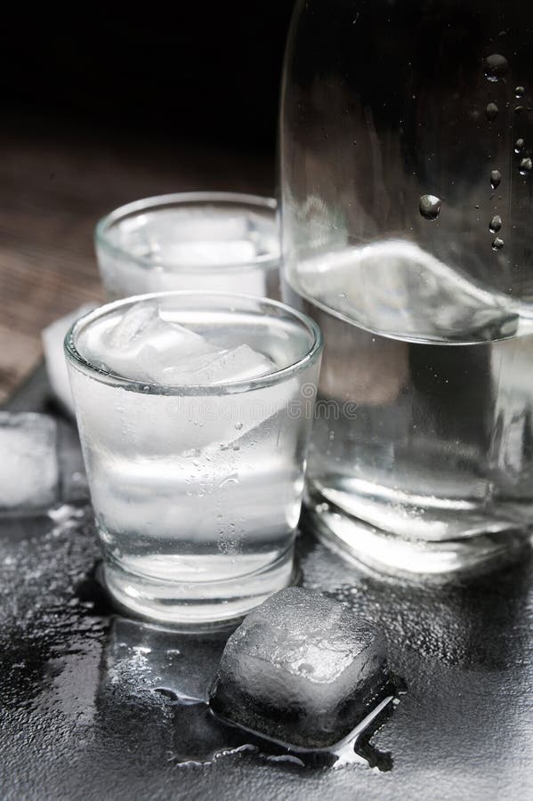 Close-up View of Bottle Vodka with Glasses Standing on Ice Black Stock ...