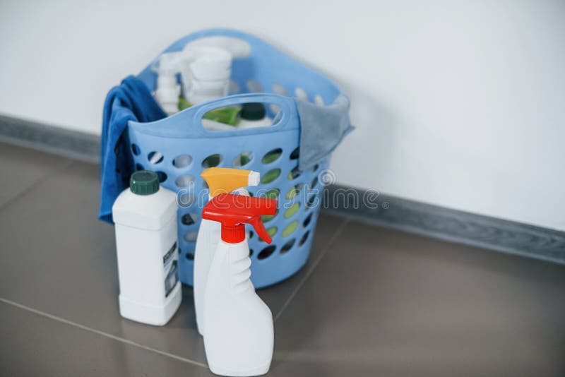 Close Up View of Bottles with Detergent and Basket Indoors on the Floor ...