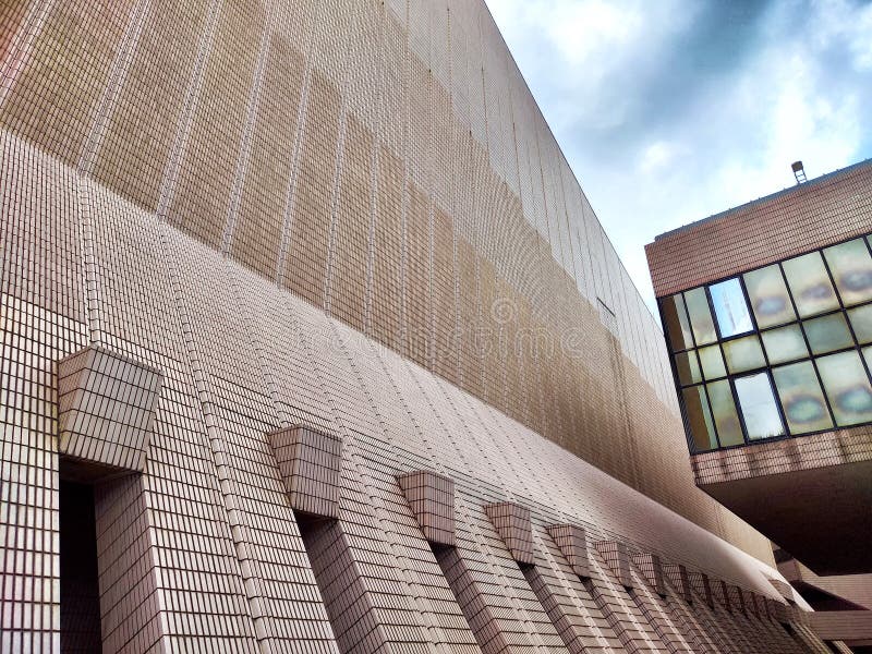 A Close-up View of a Brick-patterned Building Facade with an ...