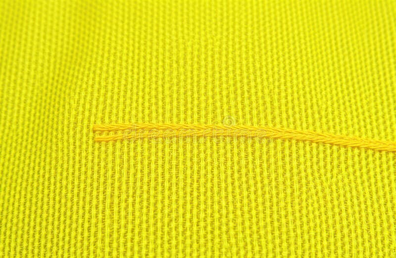 Close-up View of Bright Yellow Fabric Texture. Visible Stitches Create ...