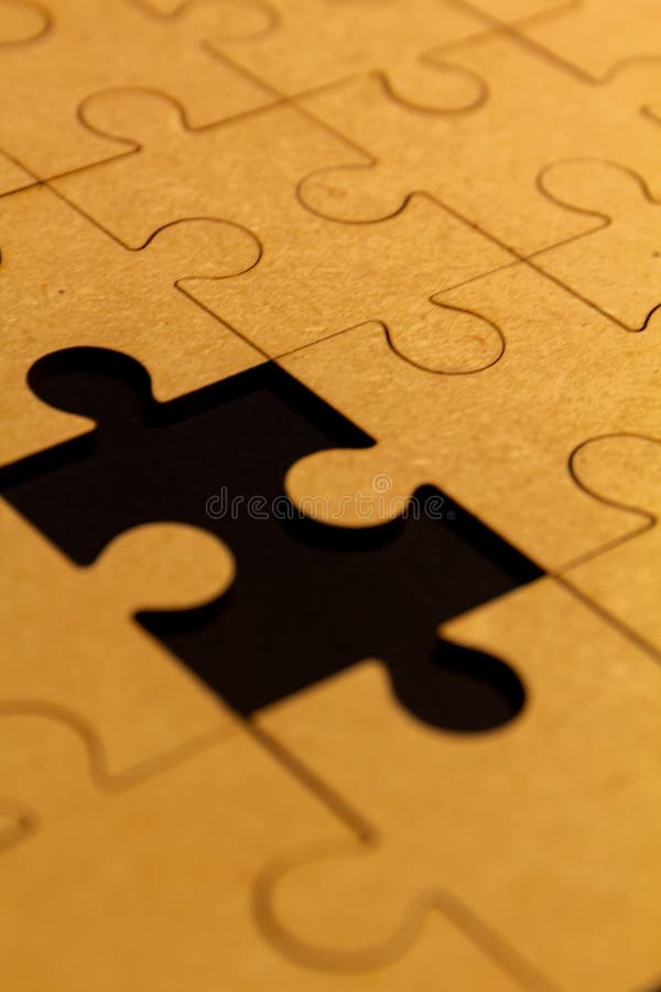 Close Up View of a Brown Puzzle with One Piece Missing Stock Photo ...