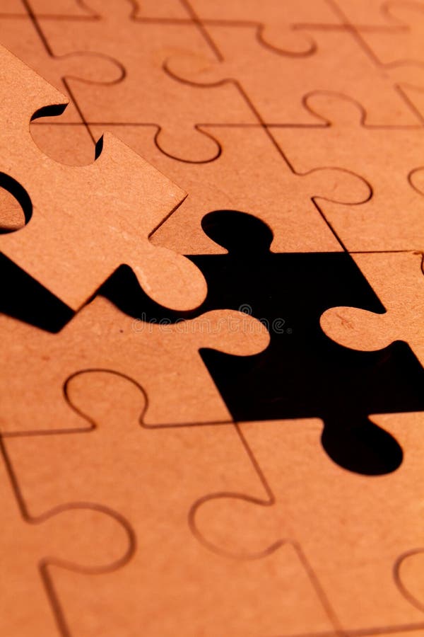 Close Up View of a Brown Puzzle with One Piece Missing Stock Image ...