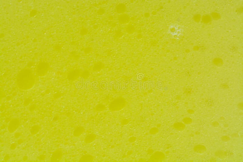 A Close-up View of Bubbles on Yellow Washing Liquid, Creating a Bubbly ...