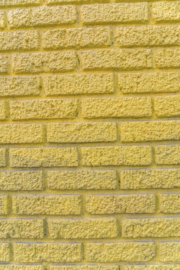 Close Up View of a Building Exterior Wall with Rough Texture and Yellow ...