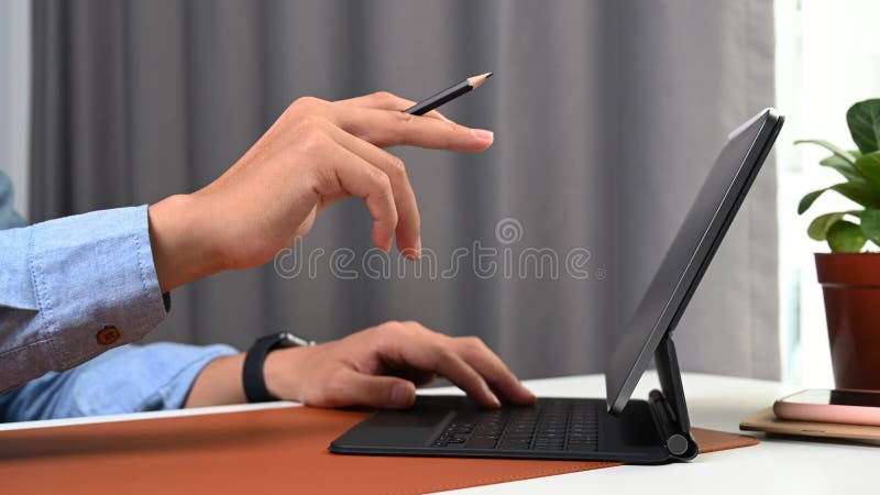 Businessman Hand Holding Pencil and Pointing on Computer Tablet. Stock ...