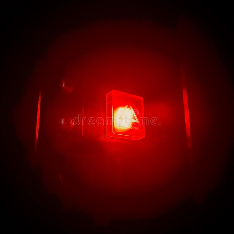 Close Up View of a Button with Bright Red Light Shining in the Dark ...