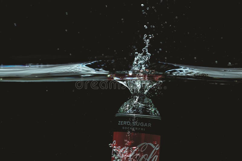 Close Up View of Can of Coca Cola Falling into Water Isolation on Black ...
