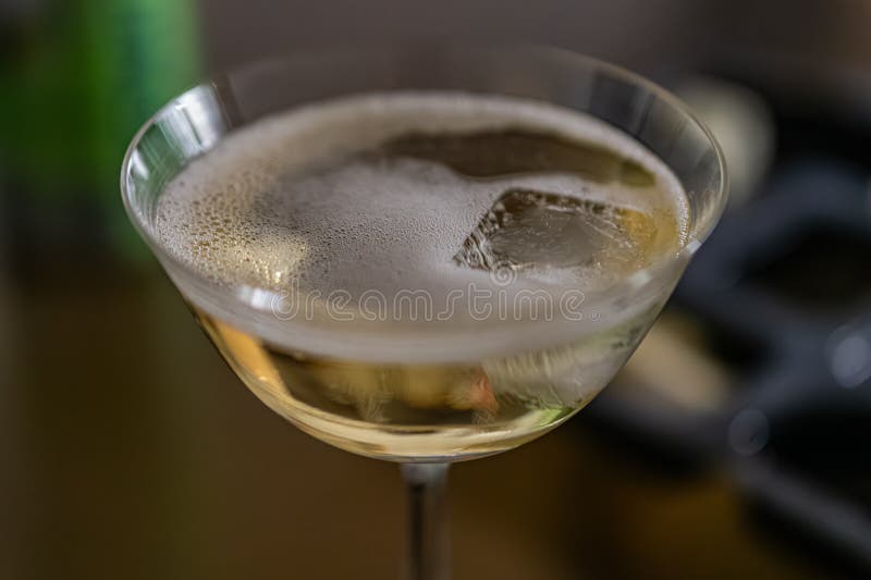 Close-up View of a Champagne Glass with Bubbly, Pale Liquid and Ice ...