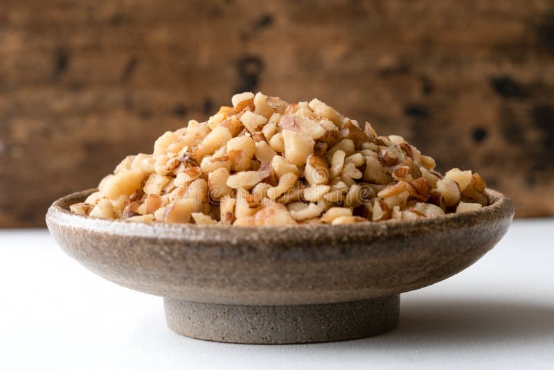 Chopped Walnuts in a Bowl stock image. Image of wood - 267184973