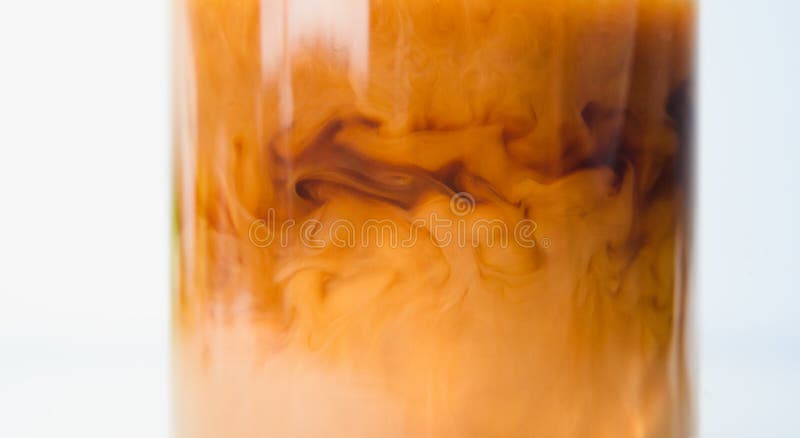 Close Up View of Coffee Mixing with Milk in Glass Stock Photo - Image ...