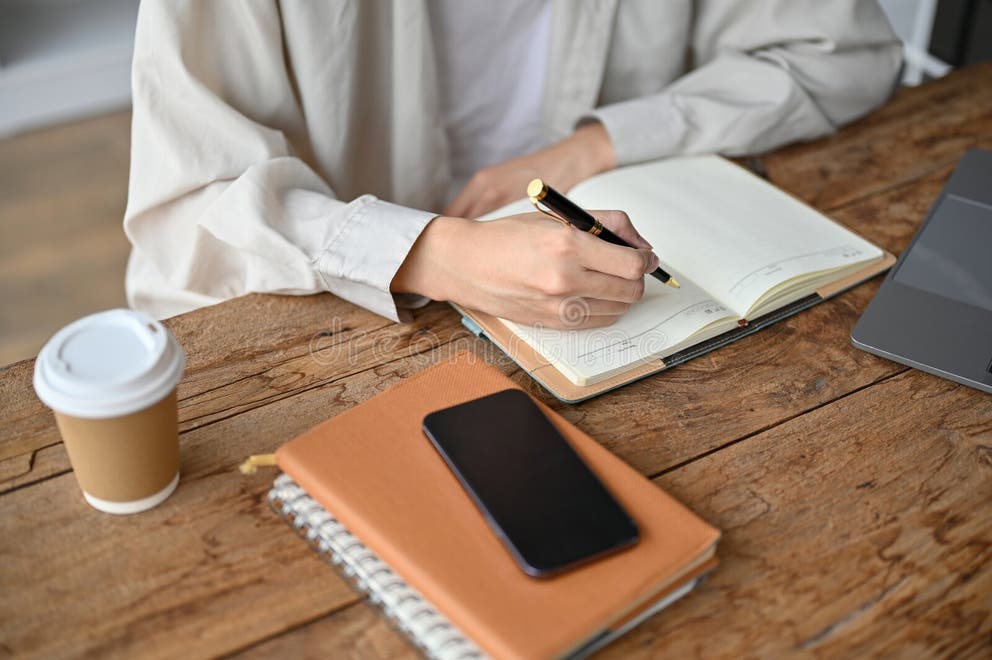A College Student Taking a Note and Reading Textbook in the Study Room ...