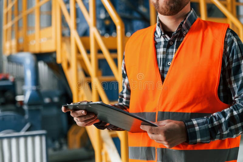 Close Up View. Construction Worker in Uniform is in the Factory Stock ...