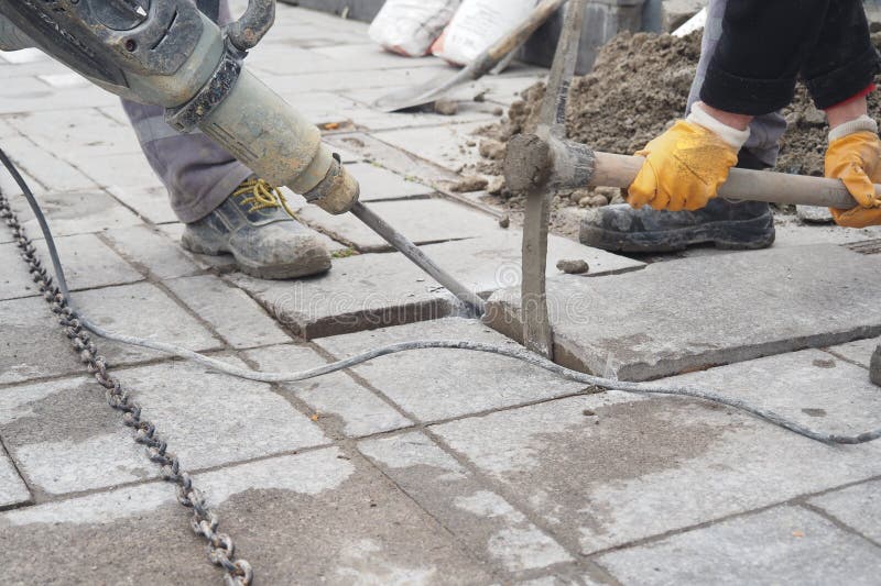 Construction Workers are Using Power Tools on the Concrete Pavement in ...