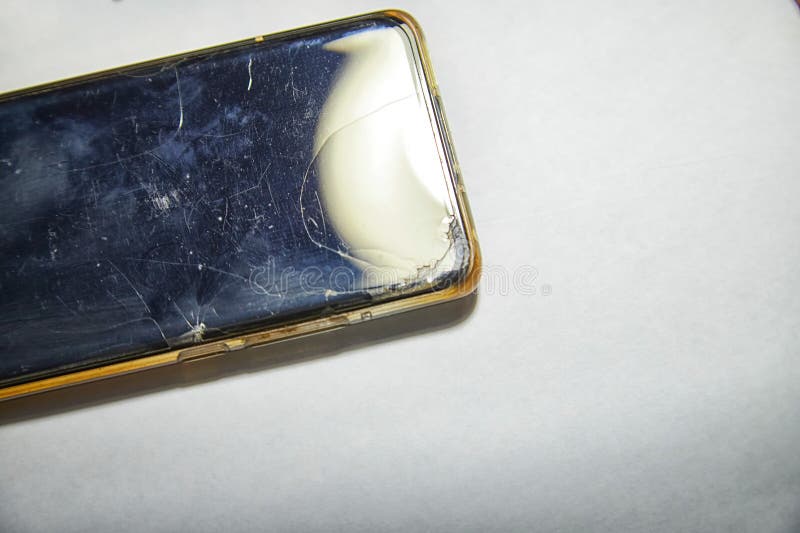 Close-Up View of a Cracked Smartphone Screen Against White Background ...