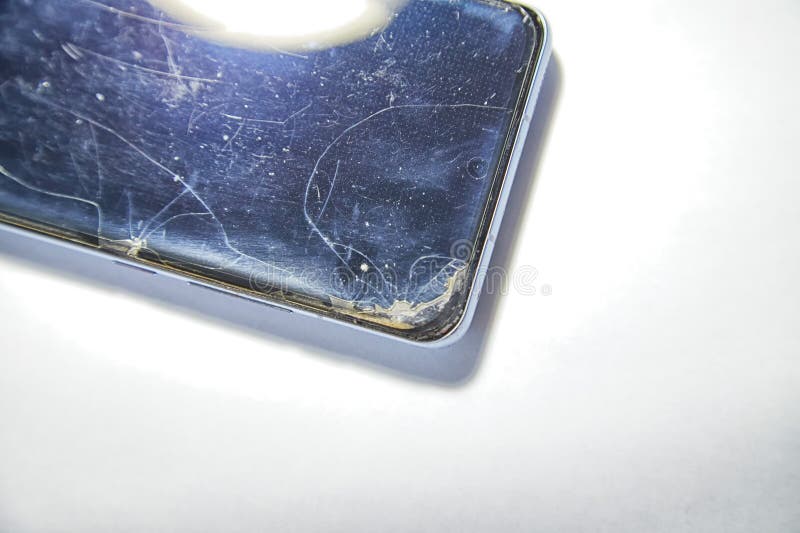 Close-Up View of a Cracked Smartphone Screen Against White Background ...