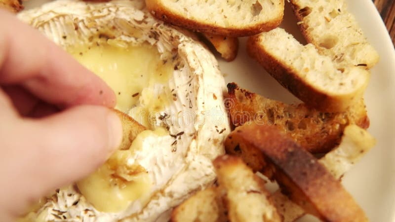 A Close-up View of a Crispy Bread Bite Being Held, Ready To Be Dipped ...