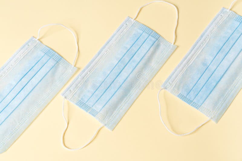 The Close-up View of the Disposable Protective Masks Lying on a Beige ...