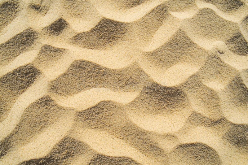 A Close-up View of Fine Sand Texture with Subtle Patterns and Varying ...