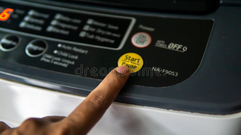 Close Up View of Finger Pushing the Start/pause Button on the Washing ...