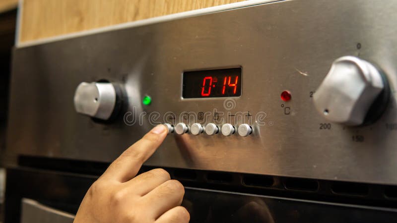 Close Up View of Girl Hand Setting Up the Timer Delay for Baking at the ...