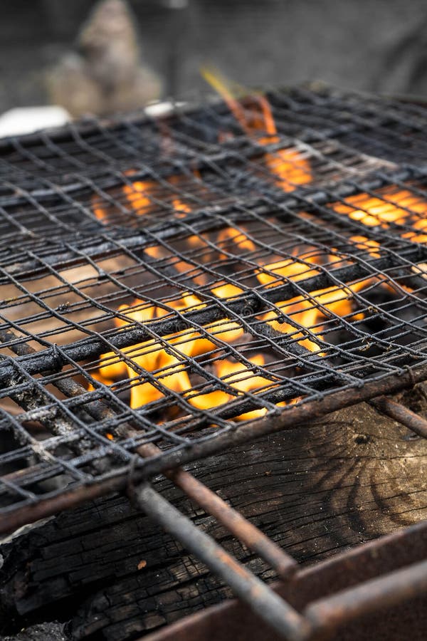 A Close-up View of a Grill with Fire Burning Underneath Stock Photo ...