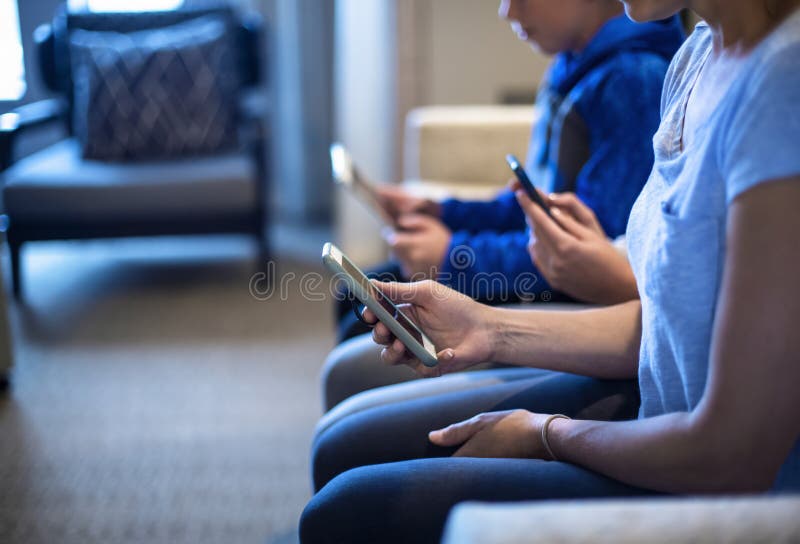 Group of People Using Their Smart Phones and Tablet Devices Together ...
