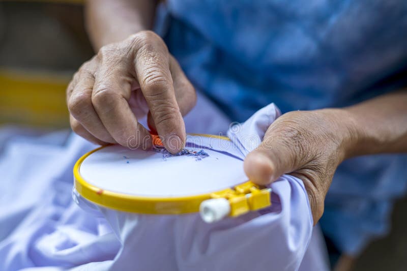 Close-up View. Hand of an Elderly Thai Woman Using a Slitting Needle To ...