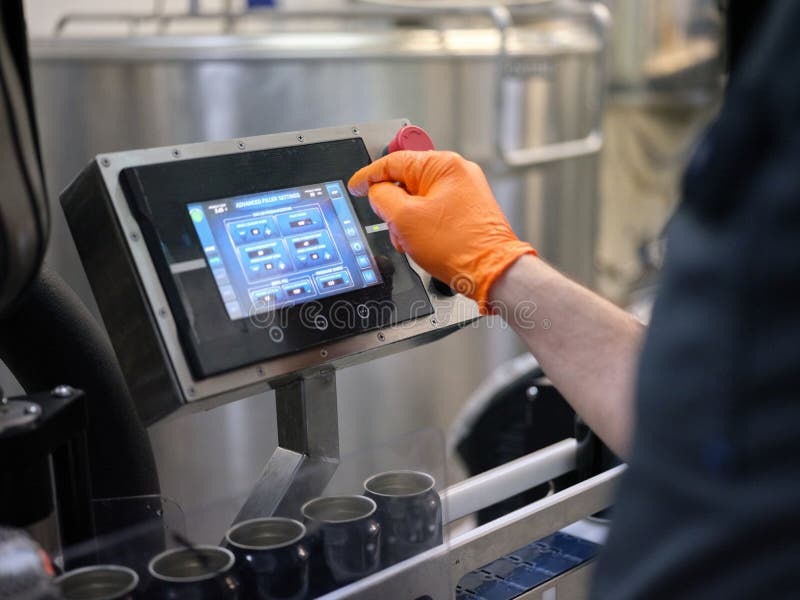 Worker Operating an Electronic Beer Filling Machine in a Brewery Stock ...