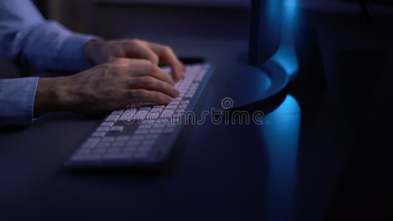 Close-up View of Hands of Freelancer Using Computer Typing Message on Wireless Keyboard at Dark ...