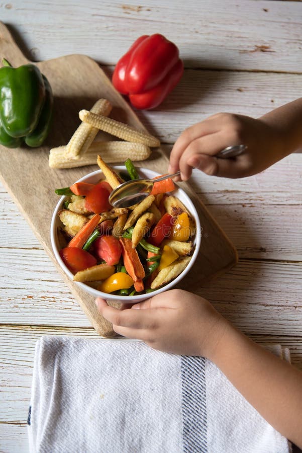 Close Up View of Hands Serving Saute Vegetables Stock Photo - Image of ...