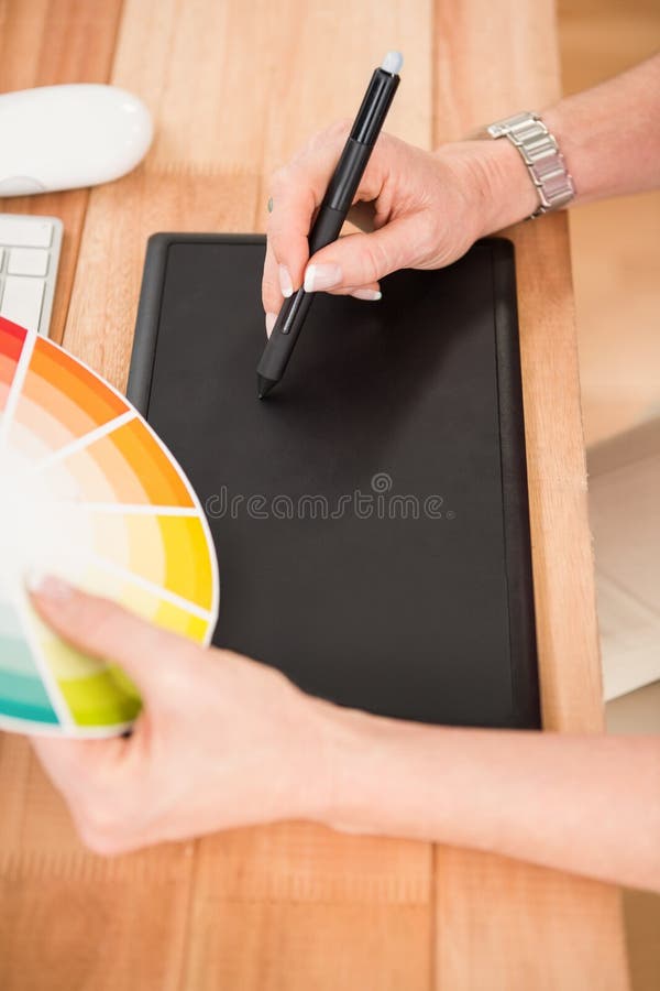 Close Up View of Hands Working with Digtizer and Colour Chart Stock ...