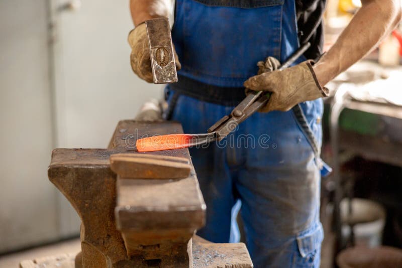 Close Up View of Heated Metal and Anvil. the Blacksmith in the ...