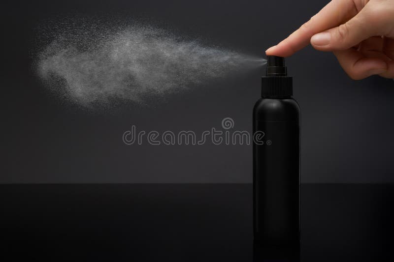 Close-up View of Human Hand and Black Spray Bottle Isolated on Black ...