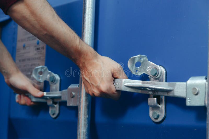 Close Up View on Man Hands is Opening the Lock of Large Shipping ...