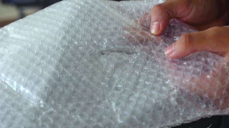 Man Bursts Bubbles on a Packaging Bubble Wrap Stock Video - Video of fragile, wrap: 257754815