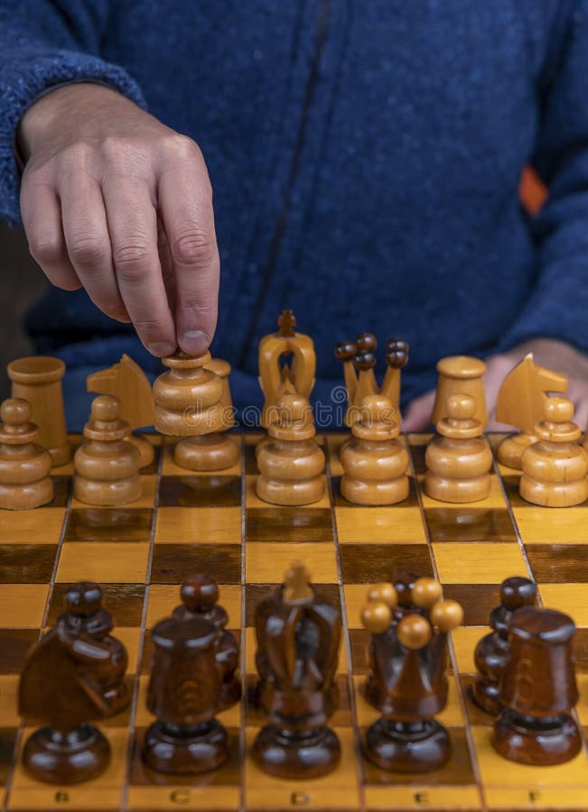 Close-up View of a Man Playing Chess on an Ancient Wooden Chess Board ...