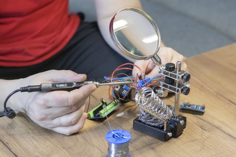 Close-up View of a Man`s Hands Using a Soldering Iron during the Repair ...