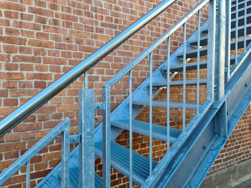 Close Up View on Metallic Stairs in Front of a Brick Wall Stock Image ...