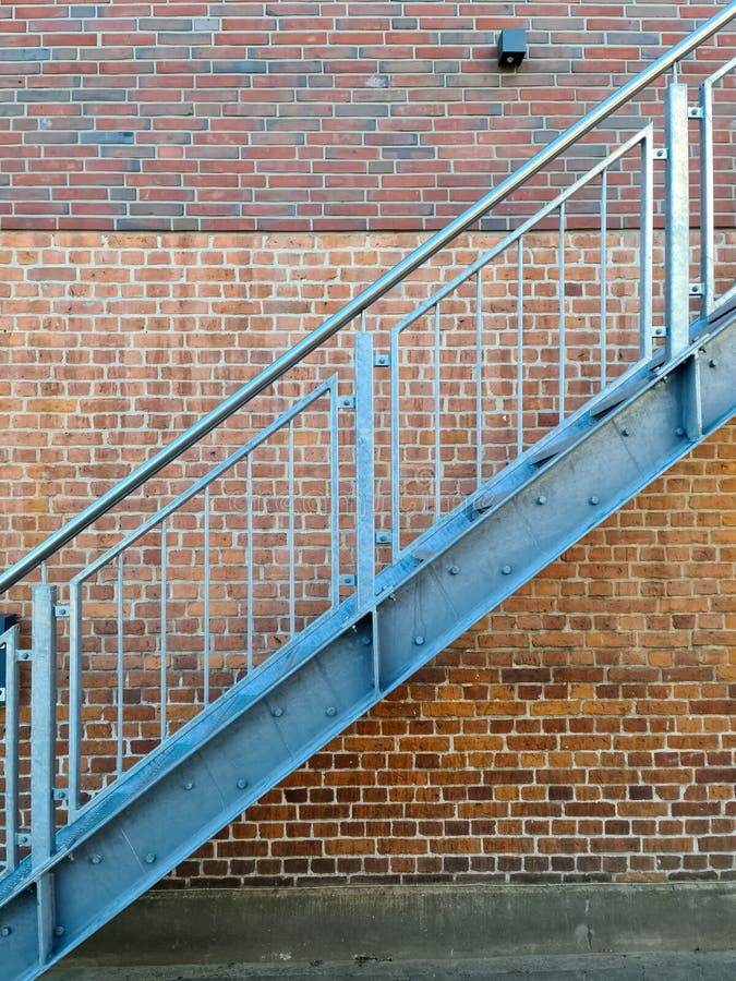 Close Up View on Metallic Stairs in Front of a Brick Wall Stock Image ...