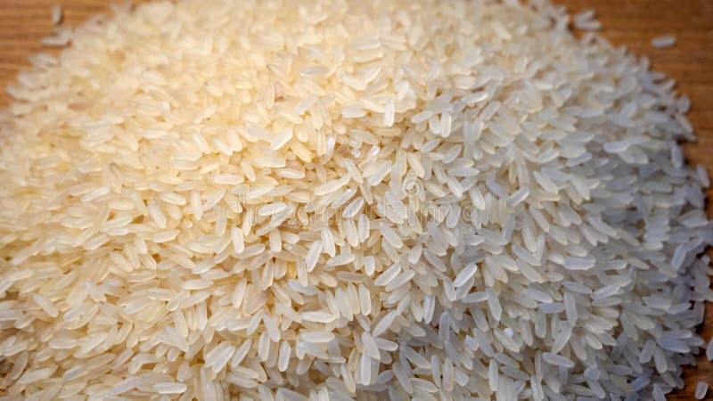 A Close-up View of a Mound of White Rice. the Grains are Densely Packed ...