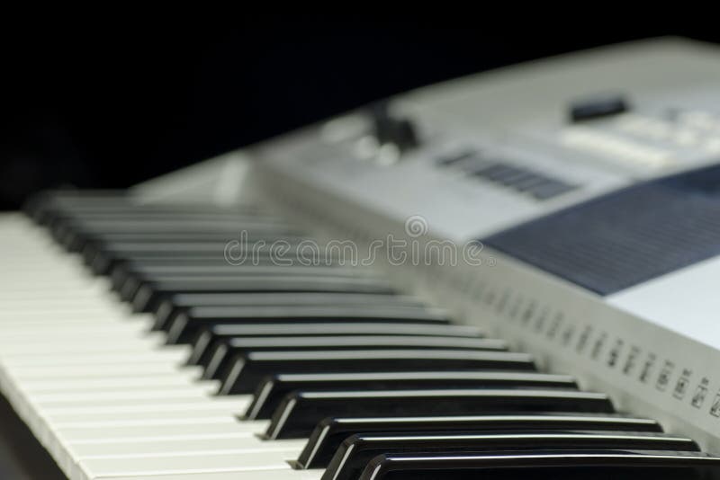 Close-up View of a Music Keyboard with Buttons and Display on a Blurred ...