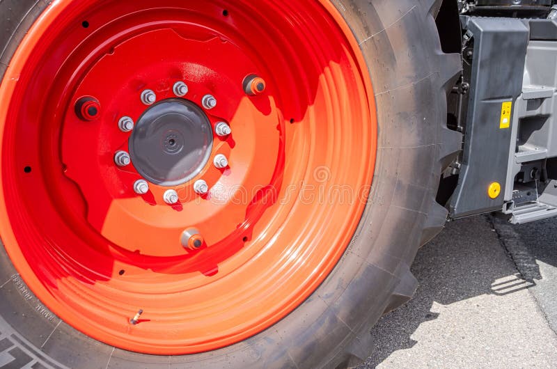 Close-up View of a New Tractor Wheel with Red Rims. Stock Photo - Image ...