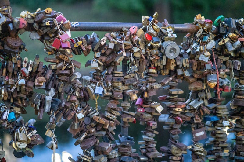 A Close-up View of Numerous Love Padlocks Attached To a Metal Railing ...