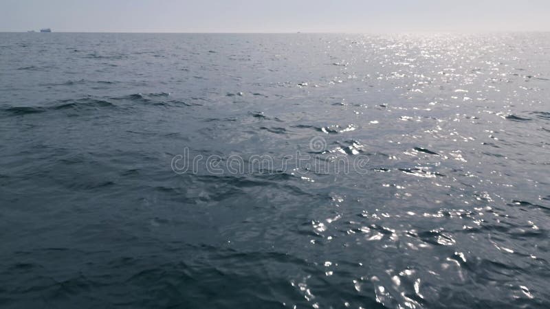 Close-up View of Ocean Surface with Gentle Ripples and Sunlight ...