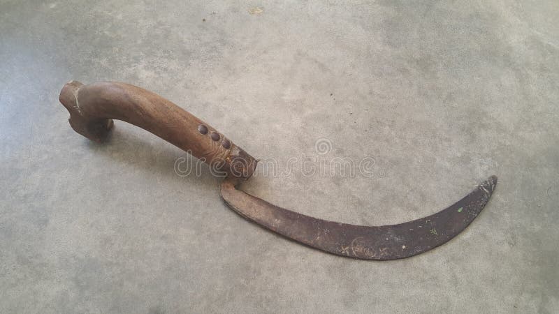 Close-up View of an Old Sickle Reaping-hook on the Concrete Surface ...