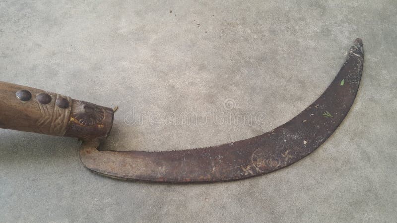 Close-up View of an Old Sickle Reaping-hook on the Concrete Surface ...