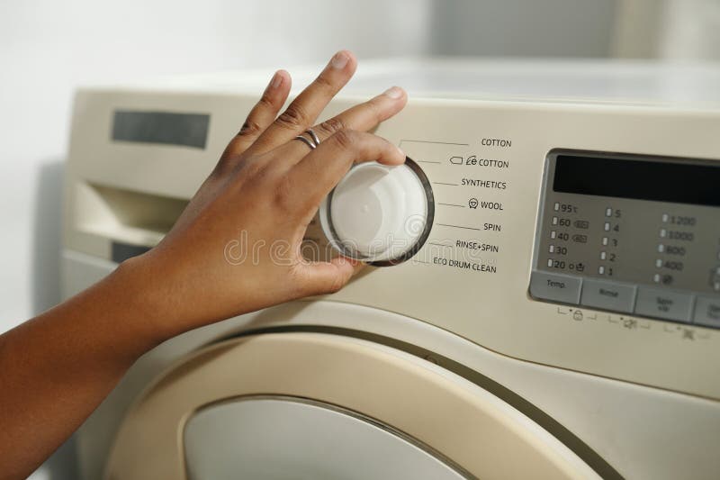 Adjusting Washing Machine Settings by Hand Stock Photo - Image of ...