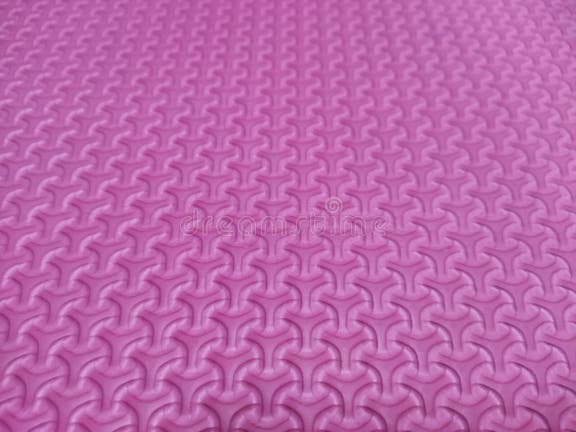 A Close-up View of a Pink Foam Mat Featuring a Repeating Geometric ...