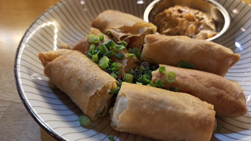 Close Up View of a Plate of Food. Spring Rolls Cut in Half and Plated ...