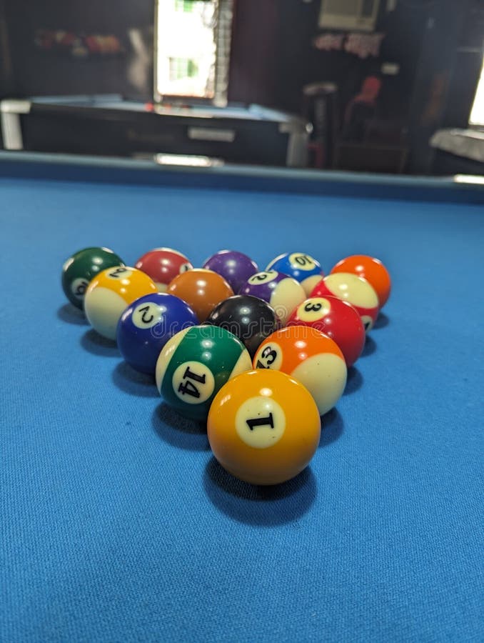 A Close-Up View of Pool Balls Arranged in a Triangle on a Blue Felt ...